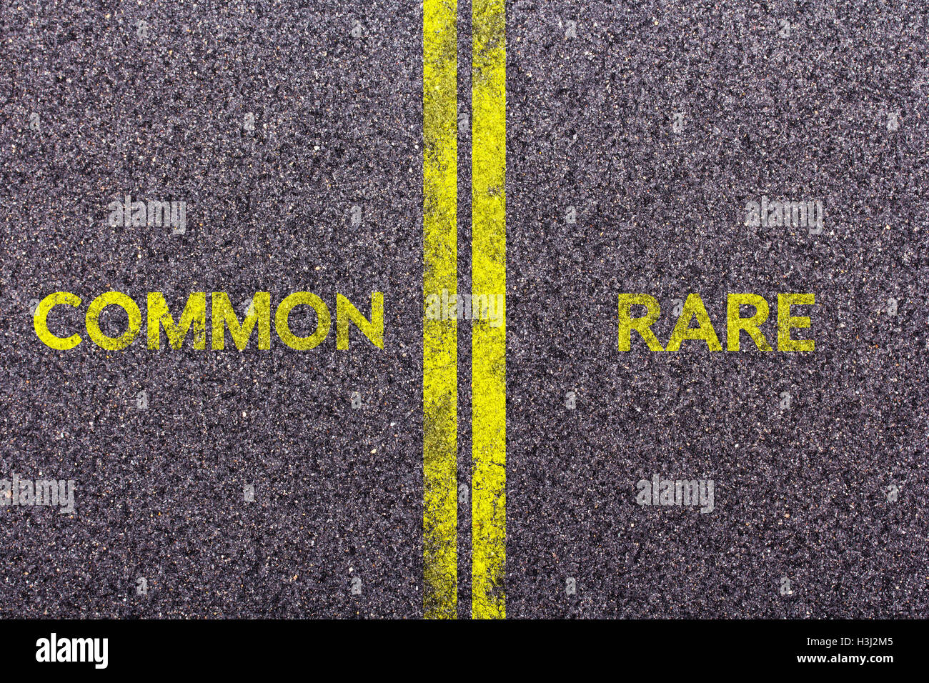 Tarmac background with the words common and rare Stock Photo - Alamy