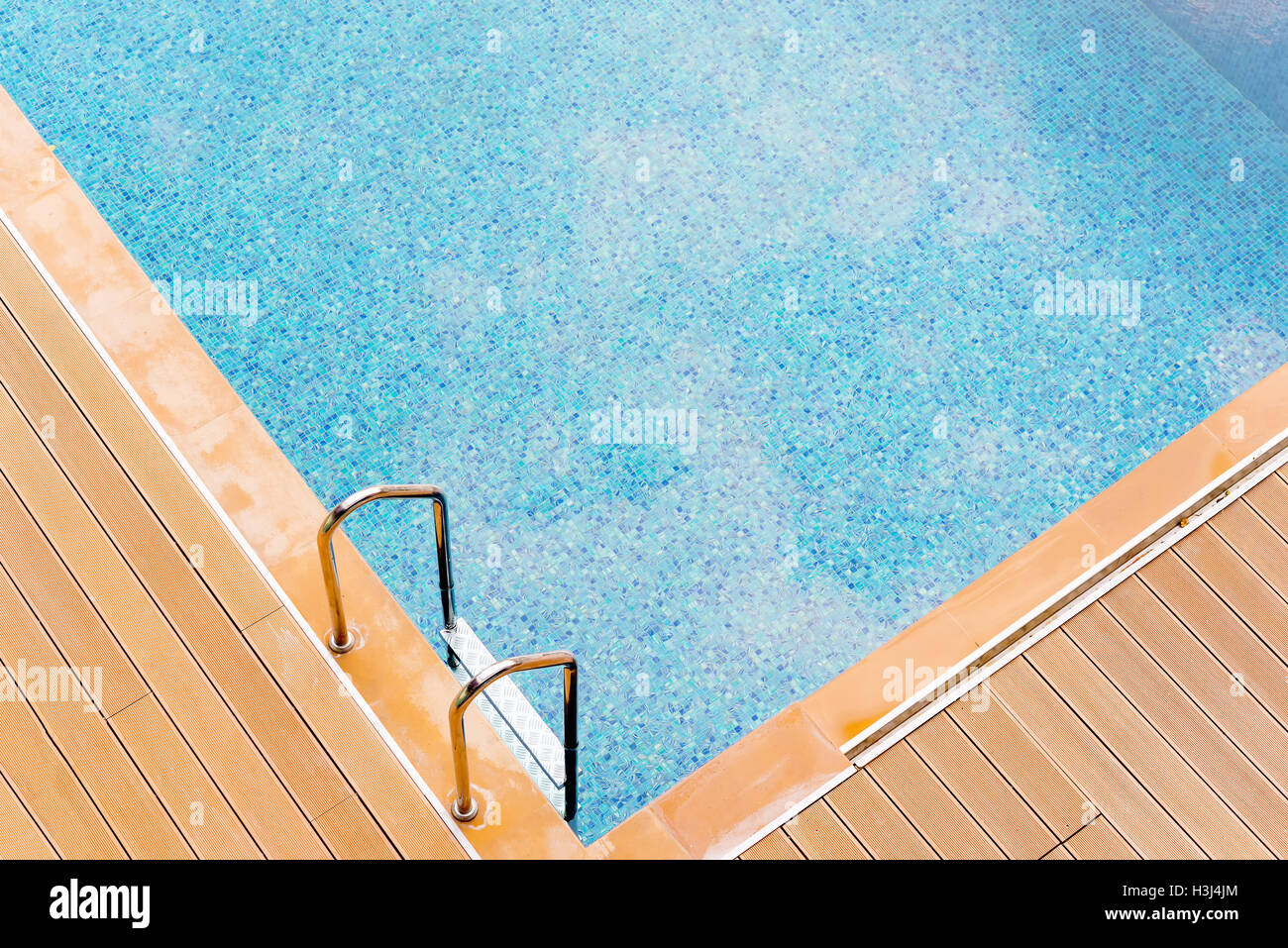 Grab bars metallic ladder entrance to clear blue swimming pool Stock ...