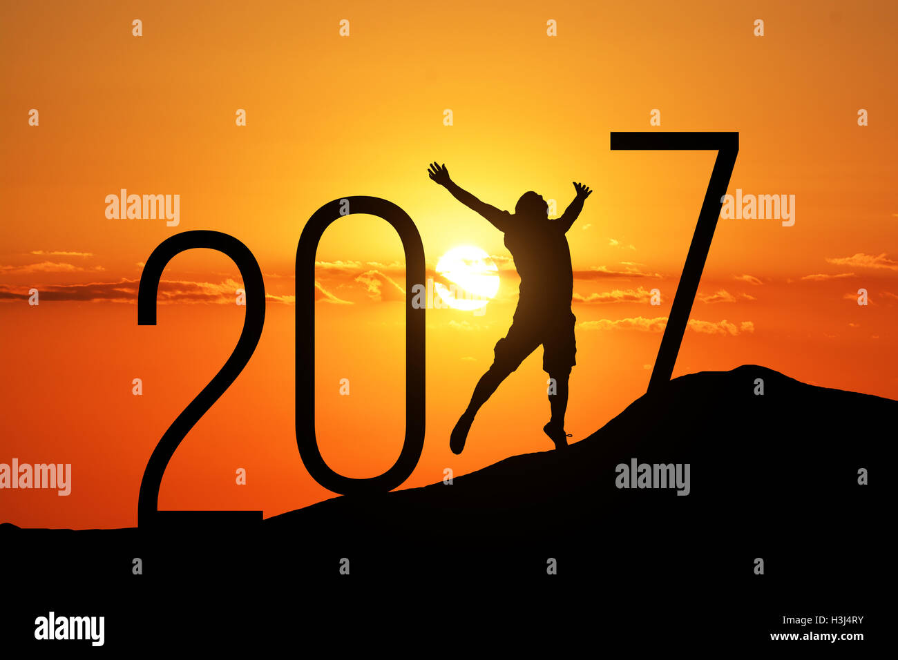 Silhouette person jumping over 2017 on the hill at sunset Stock Photo ...