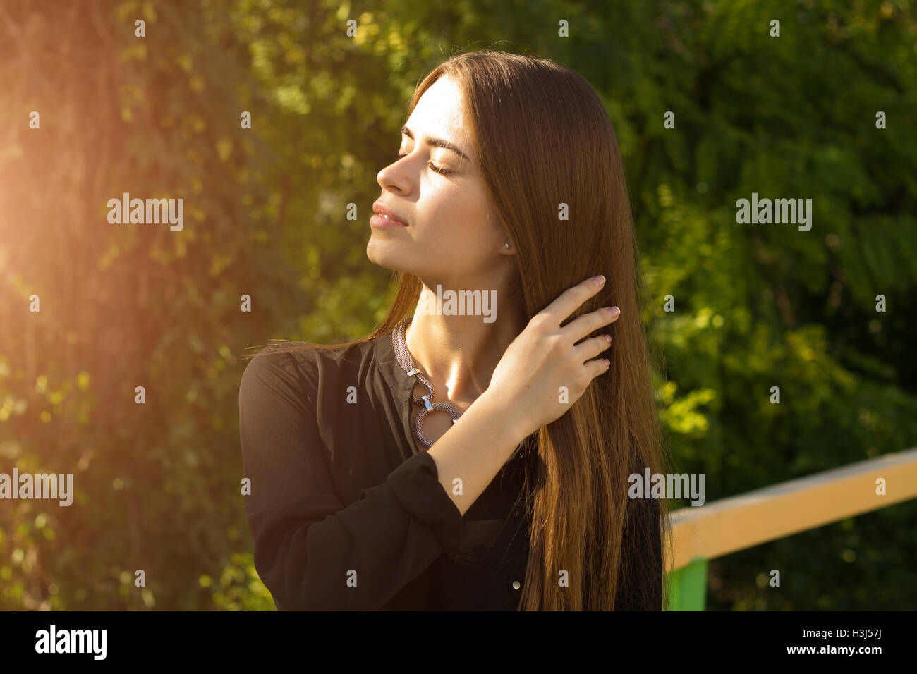 Young woman enjoying sunlight Stock Photo - Alamy
