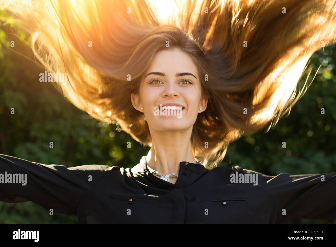 Woman throwing up her long hair Stock Photo - Alamy