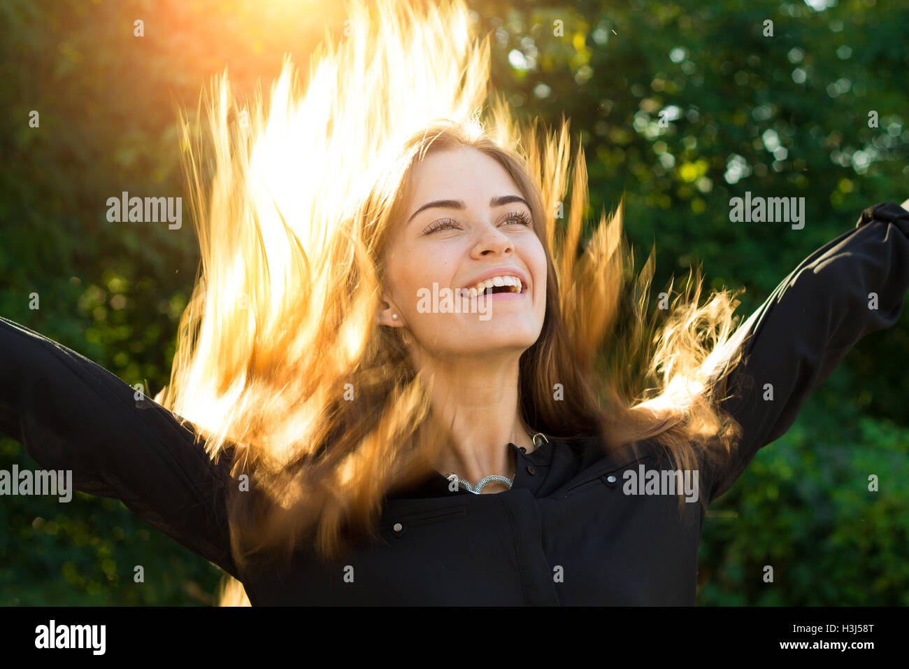 Woman throwing up her long hair Stock Photo - Alamy