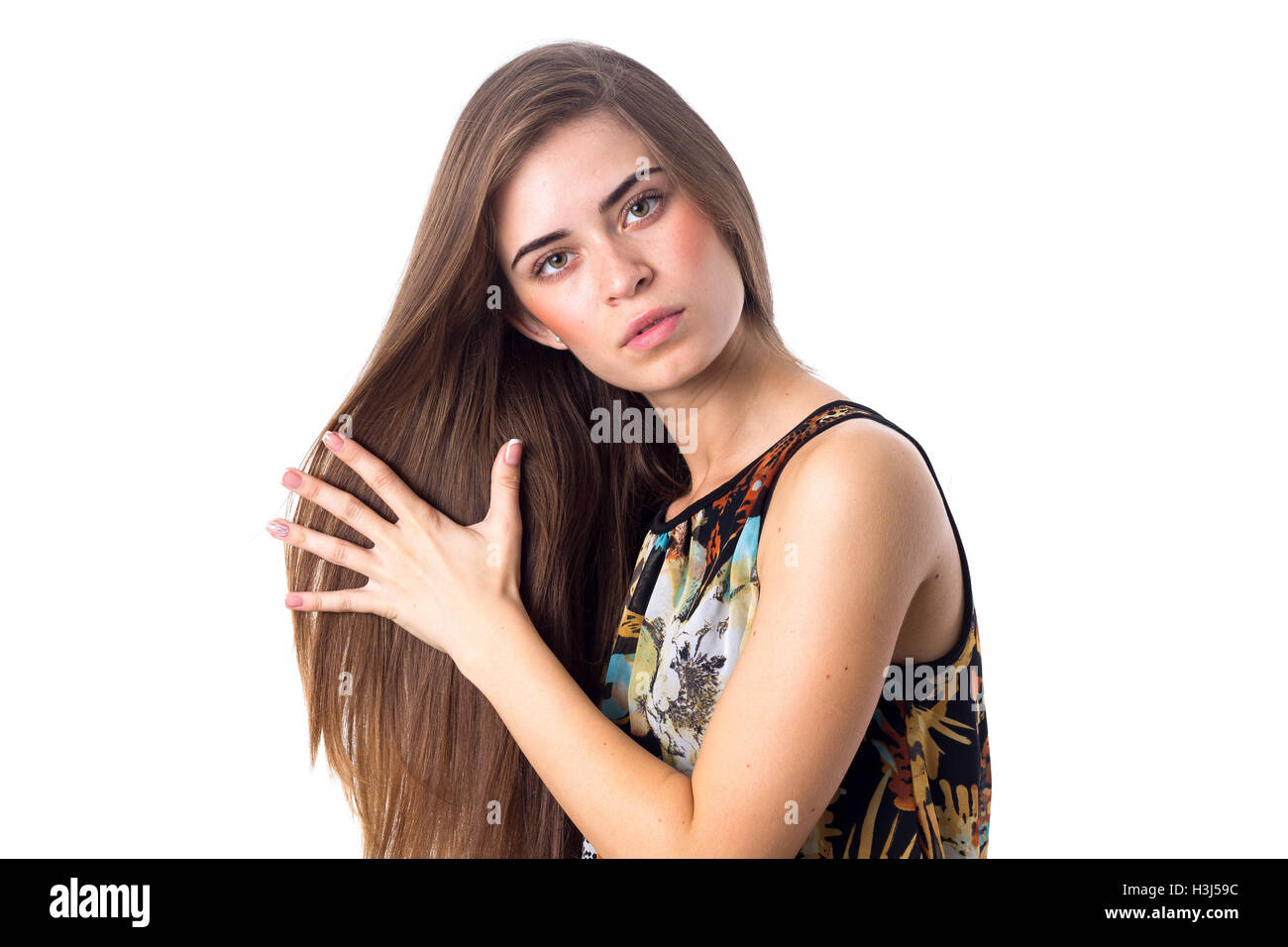 Young woman touching her hair Stock Photo - Alamy