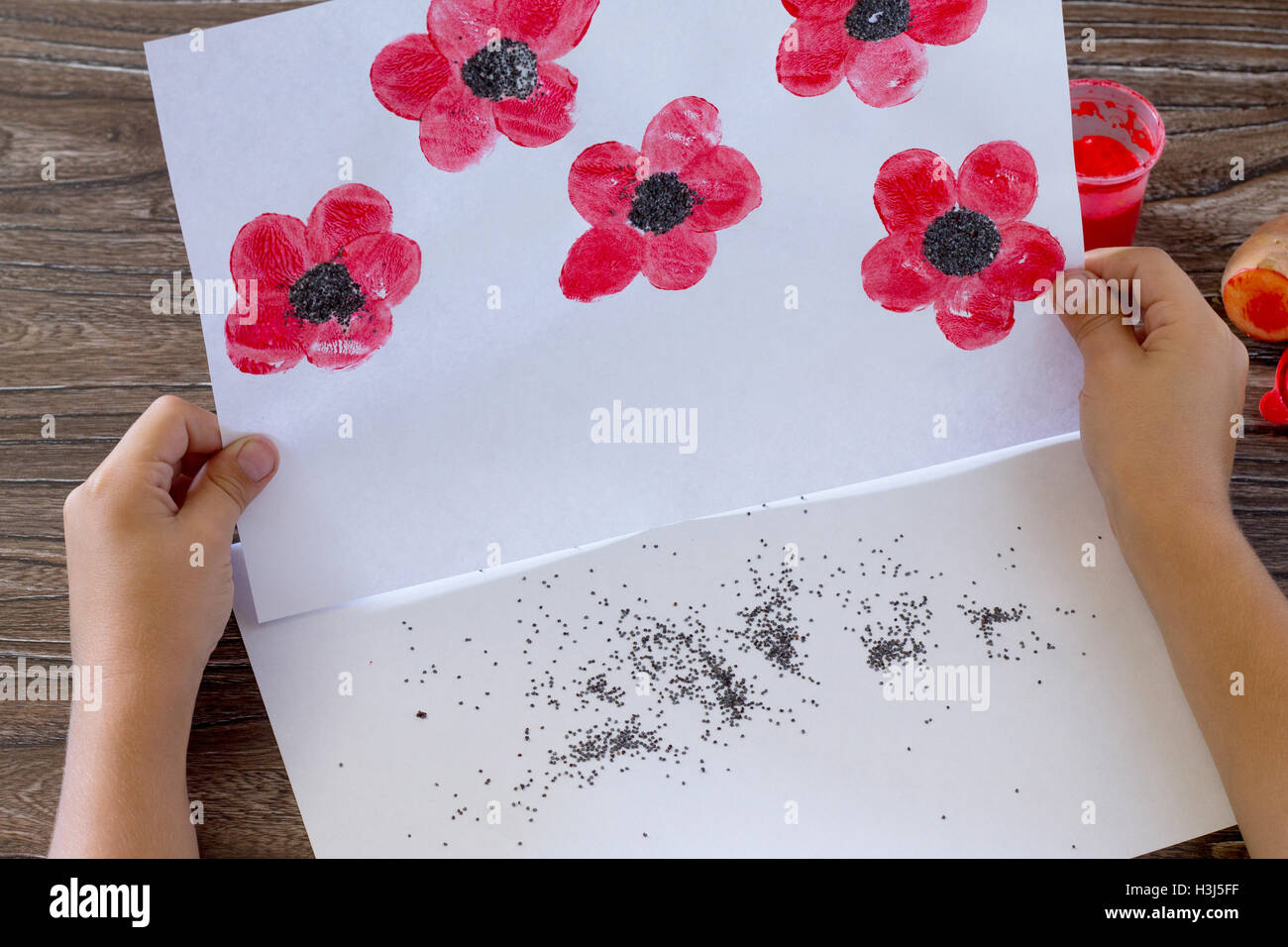 Drawing on paper poppies, child draws poppy seeds. Glue, paint, paper ...