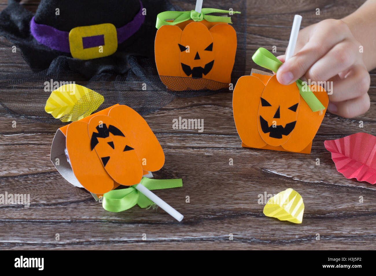 The child create a greeting packaging for candy on Halloween pumpkin ...