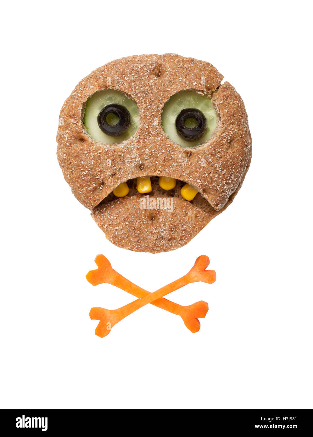 Halloween skull made of bread and vegetables on white background Stock ...