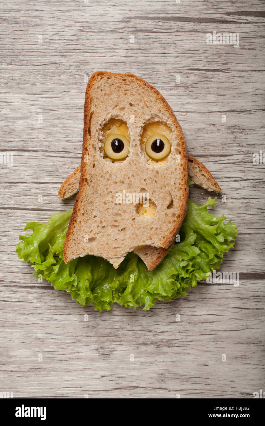Halloween ghost made of bread and salad on desk Stock Photo - Alamy