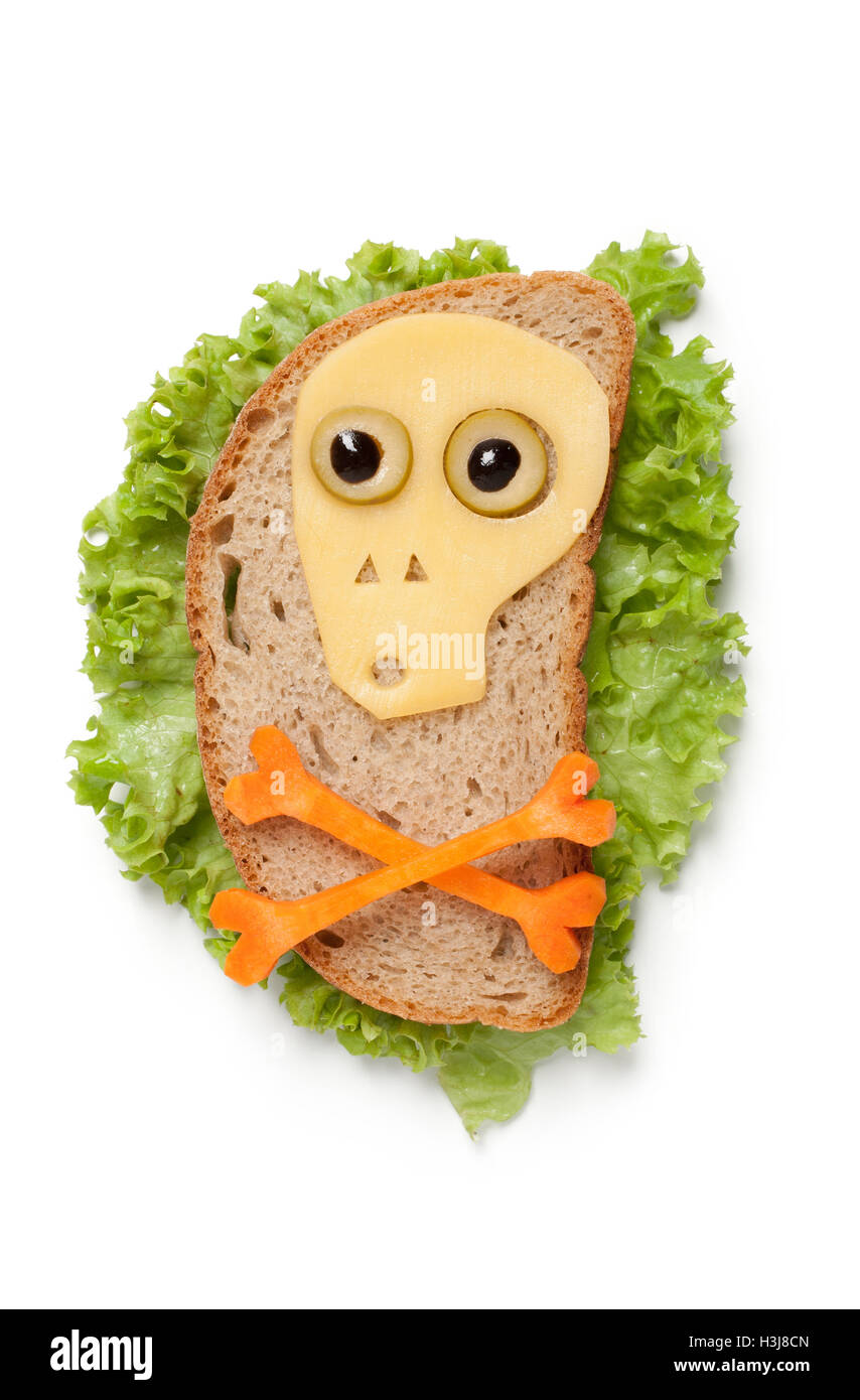 Halloween skull made of bread and vegetables on white background Stock ...