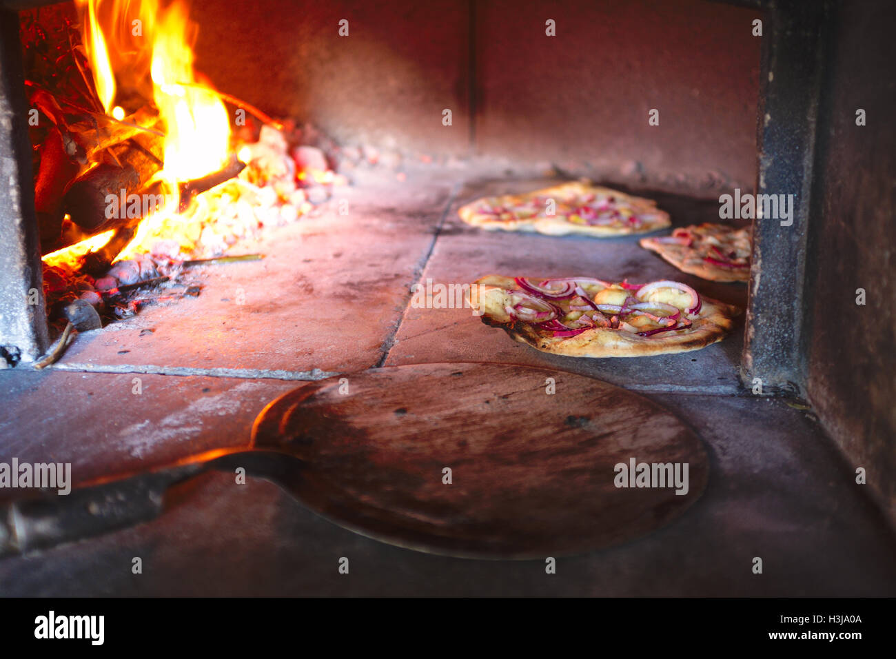 Homemade pizzas cooking in a wood-fired oven Stock Photo - Alamy