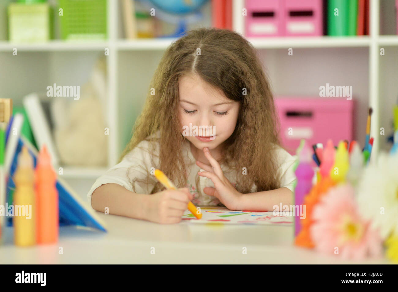 Little girl drawing at class Stock Photo - Alamy