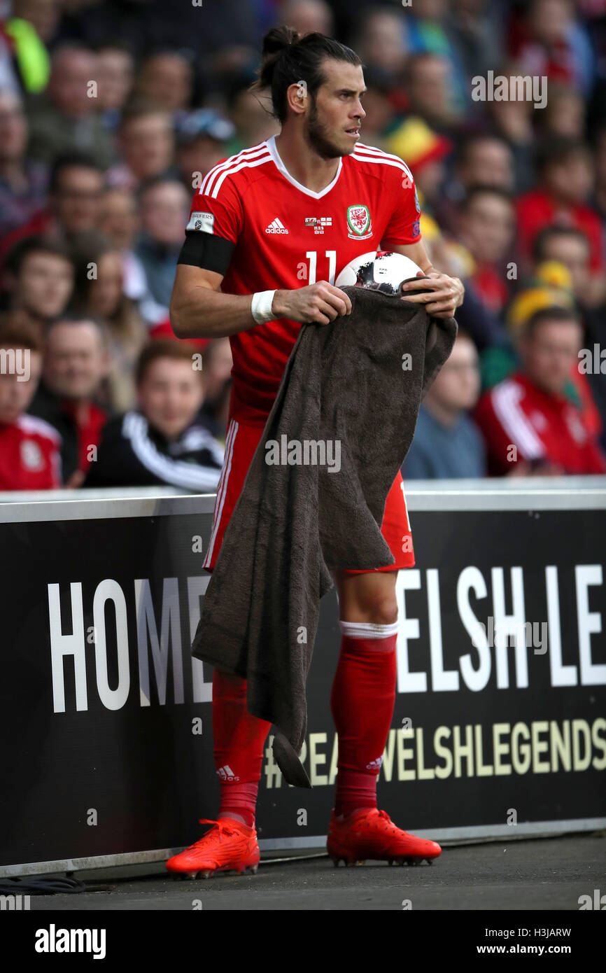 Wales' Gareth Bale wipes the match ball before delivering a long throw ...