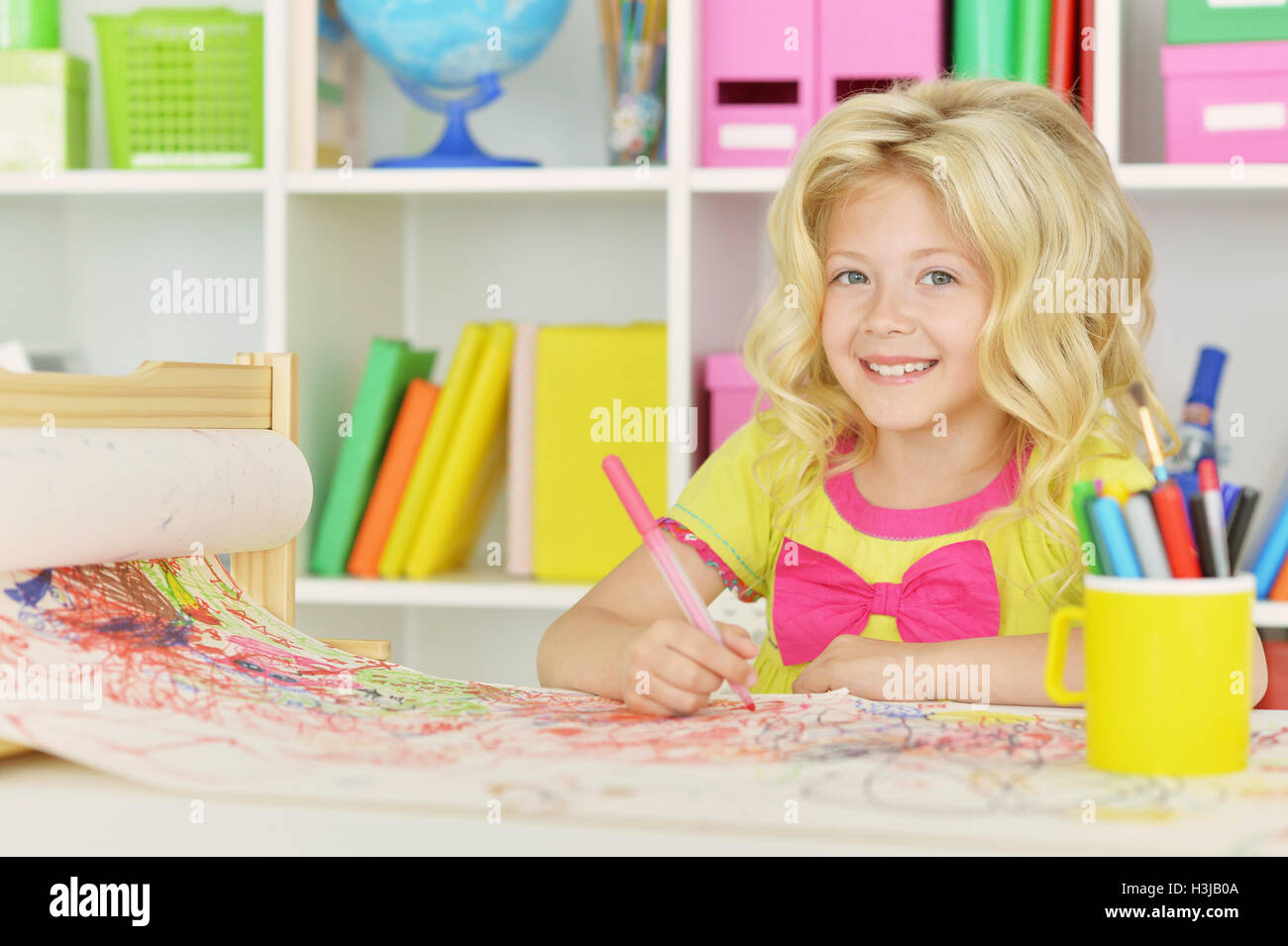 Little girl drawing at class Stock Photo - Alamy
