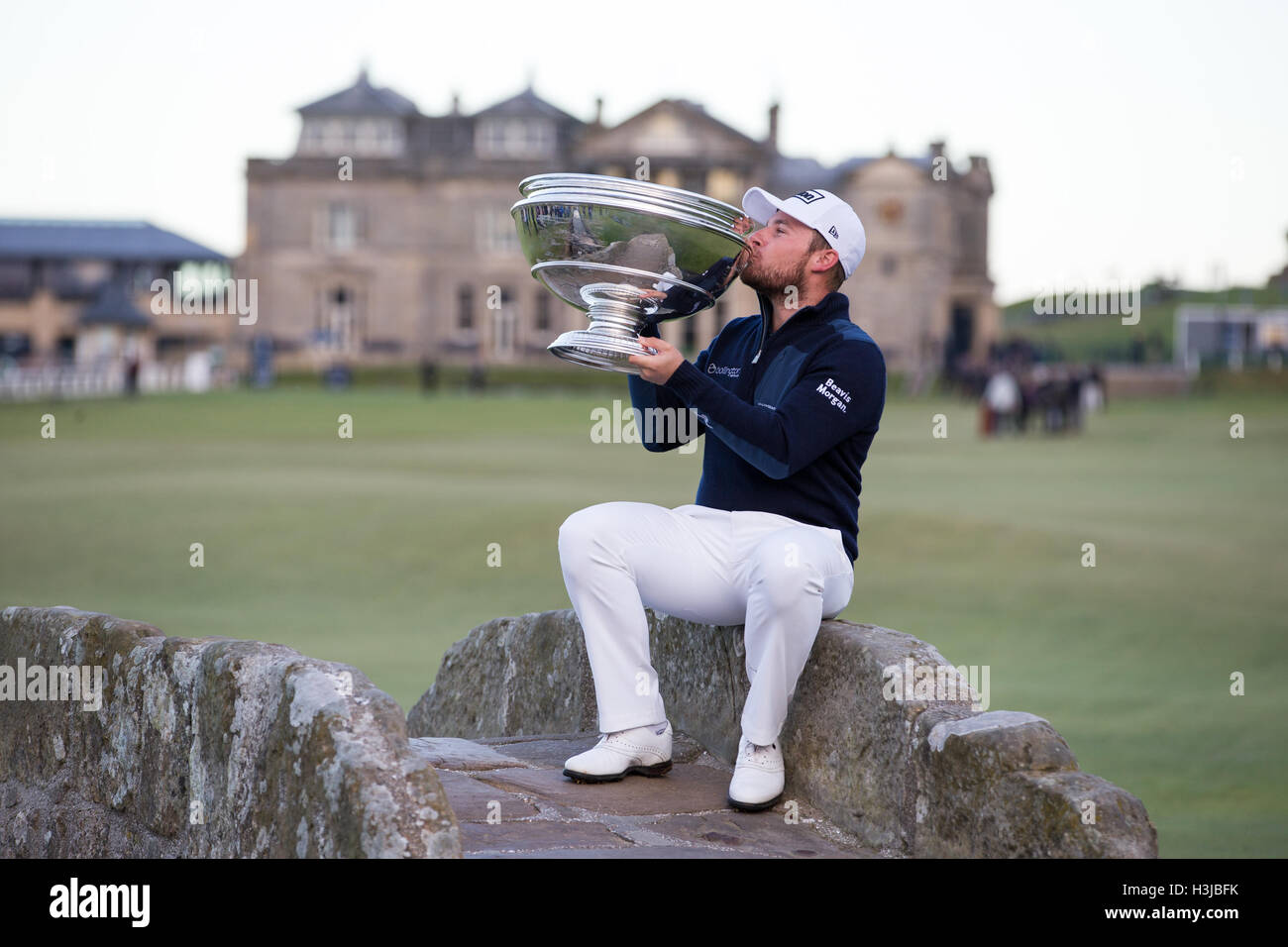 England's Tyrell Hatton poses with the trophy on the Swilken Bridge ...