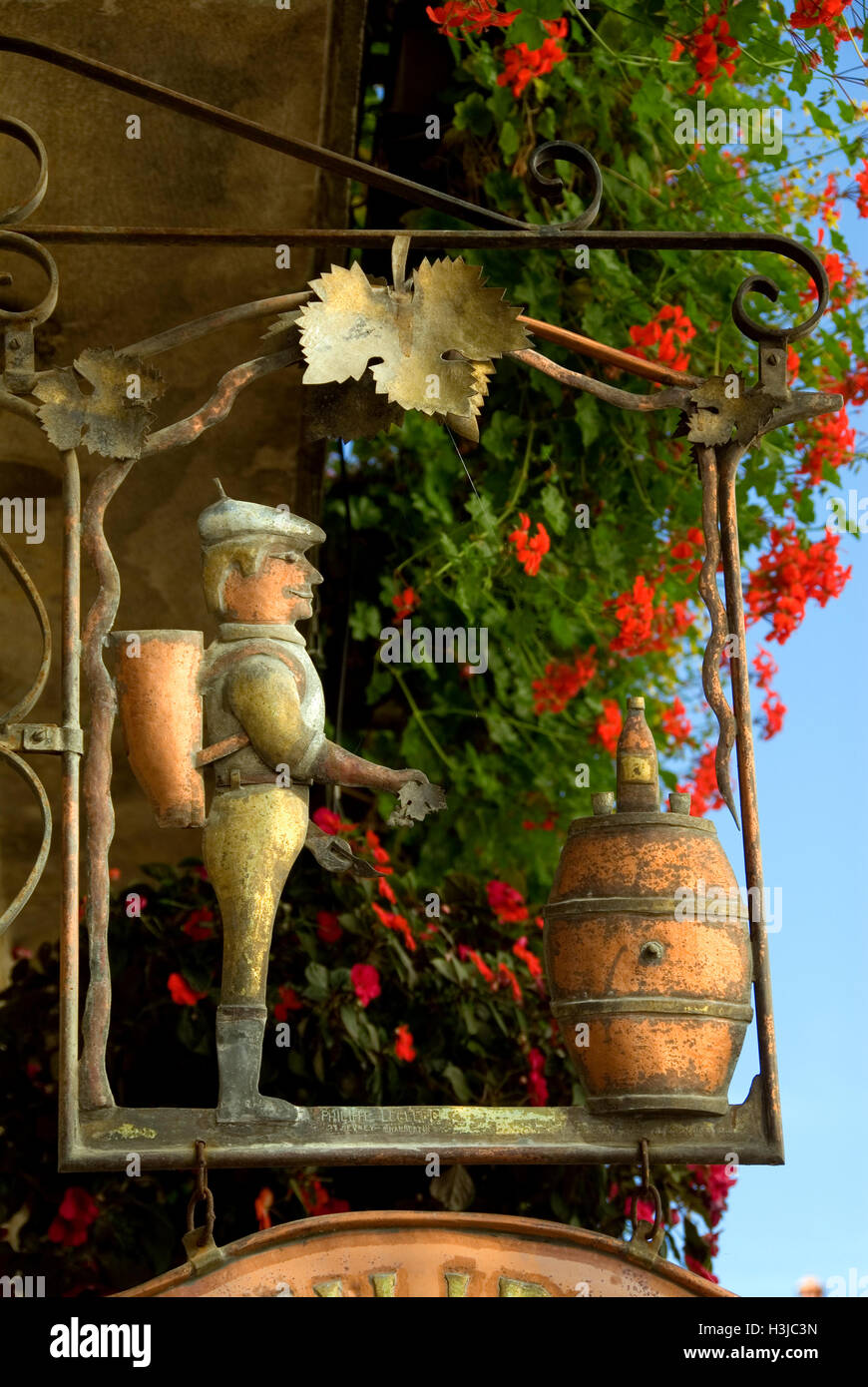 French harvester and barrel ornate metal sign outside the winery of ...