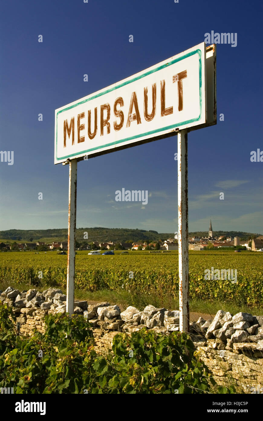 Meursault sign with vineyards, village and church behind, Cote d'Or ...