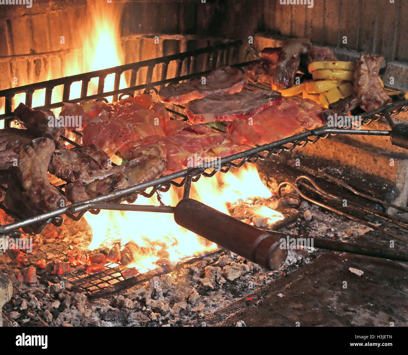 hot fire to cook pork ribs and tasty spicy sausage grilled in the ...