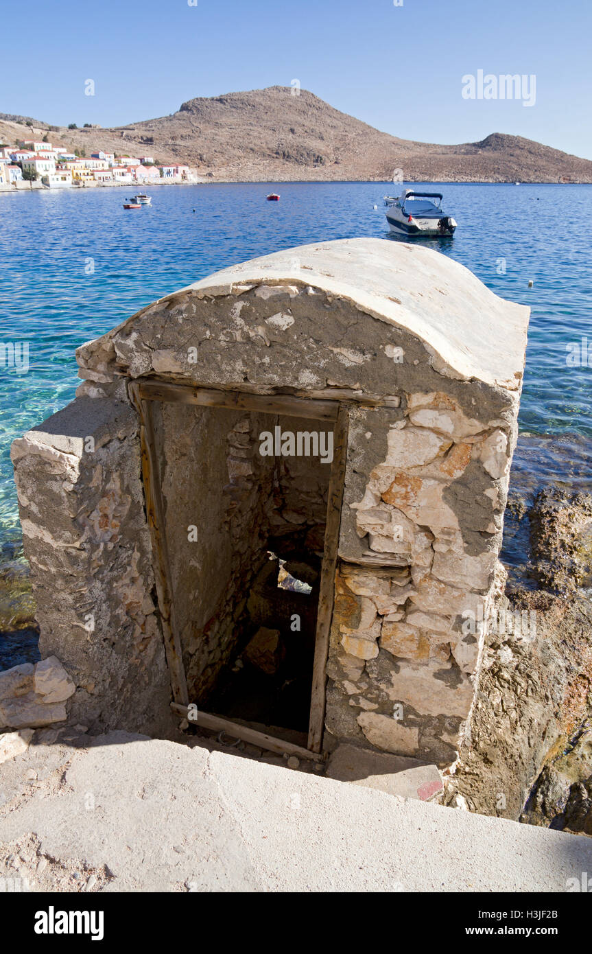 Old disused outside toilet, emptying straight into the harbour, Chalki ...