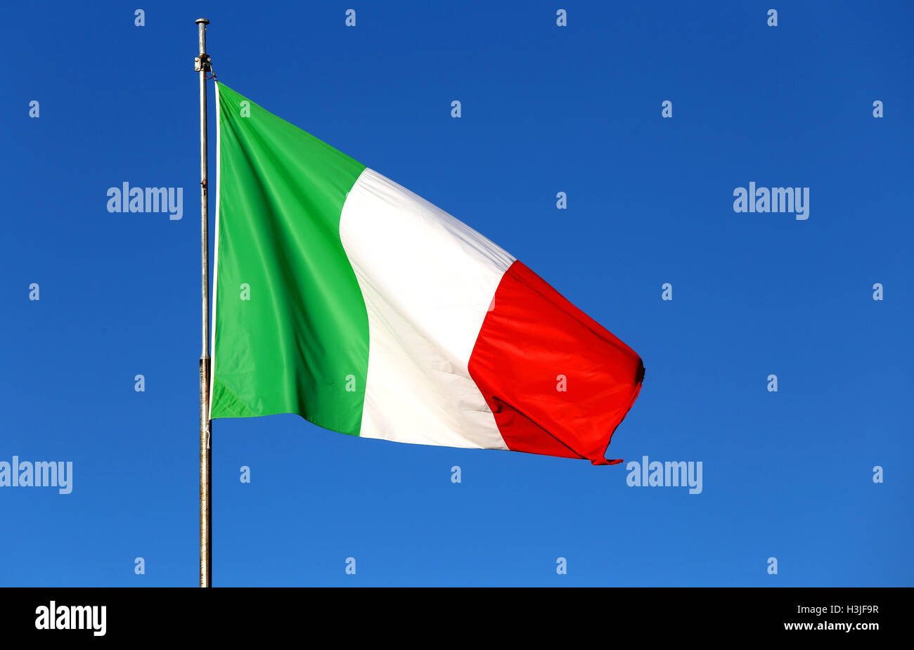 big Italian flag with the colors red white and green and the blue sky ...