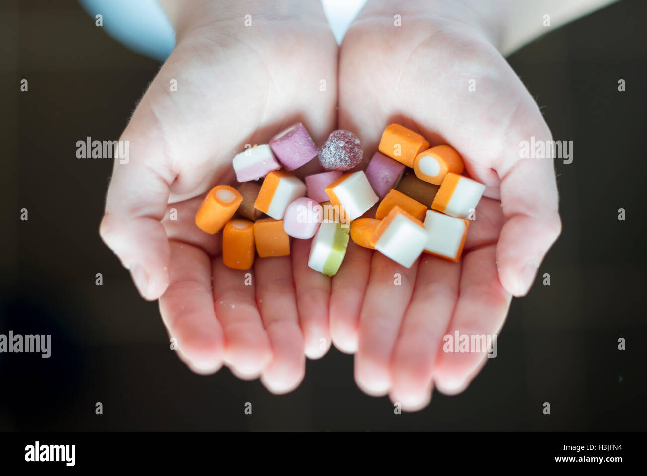 A boy holding sweets Stock Photo - Alamy