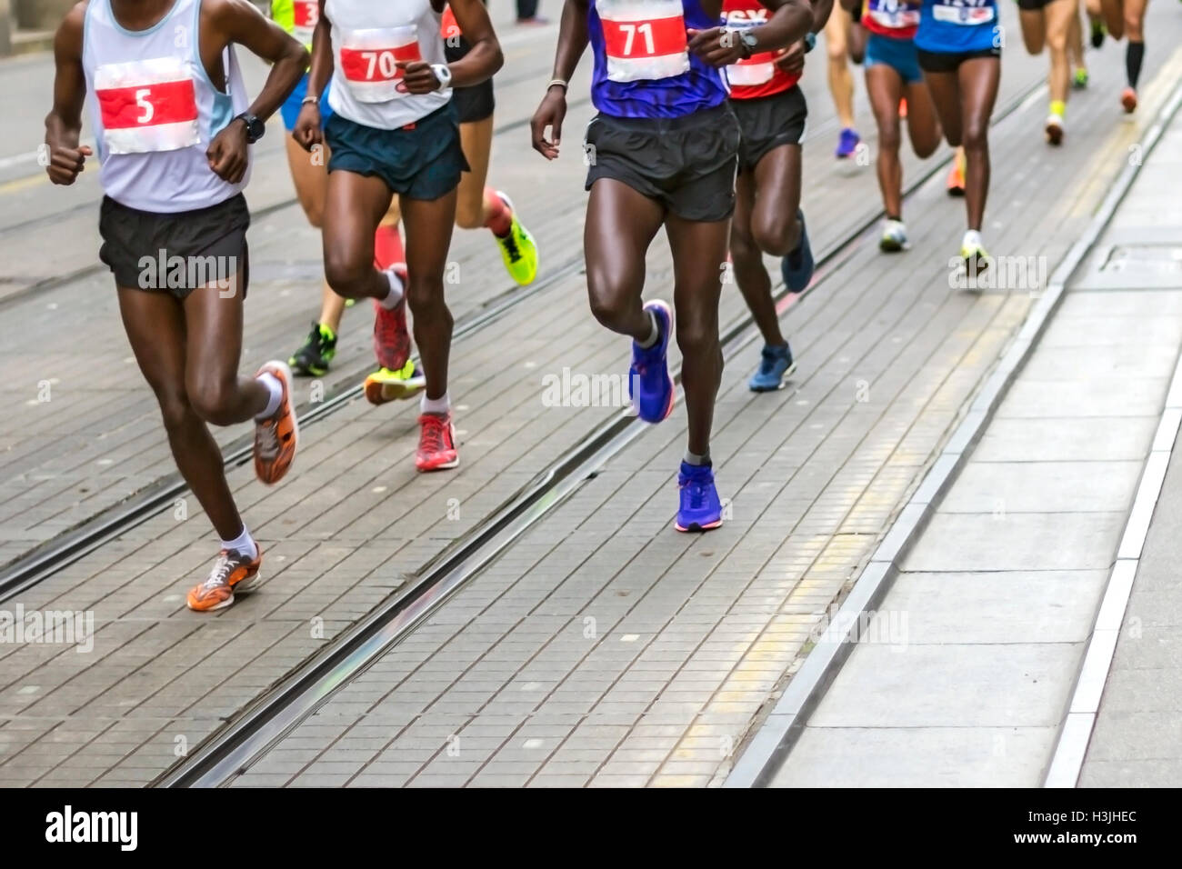 Marathon runners race in city streets, blurred motion Stock Photo - Alamy