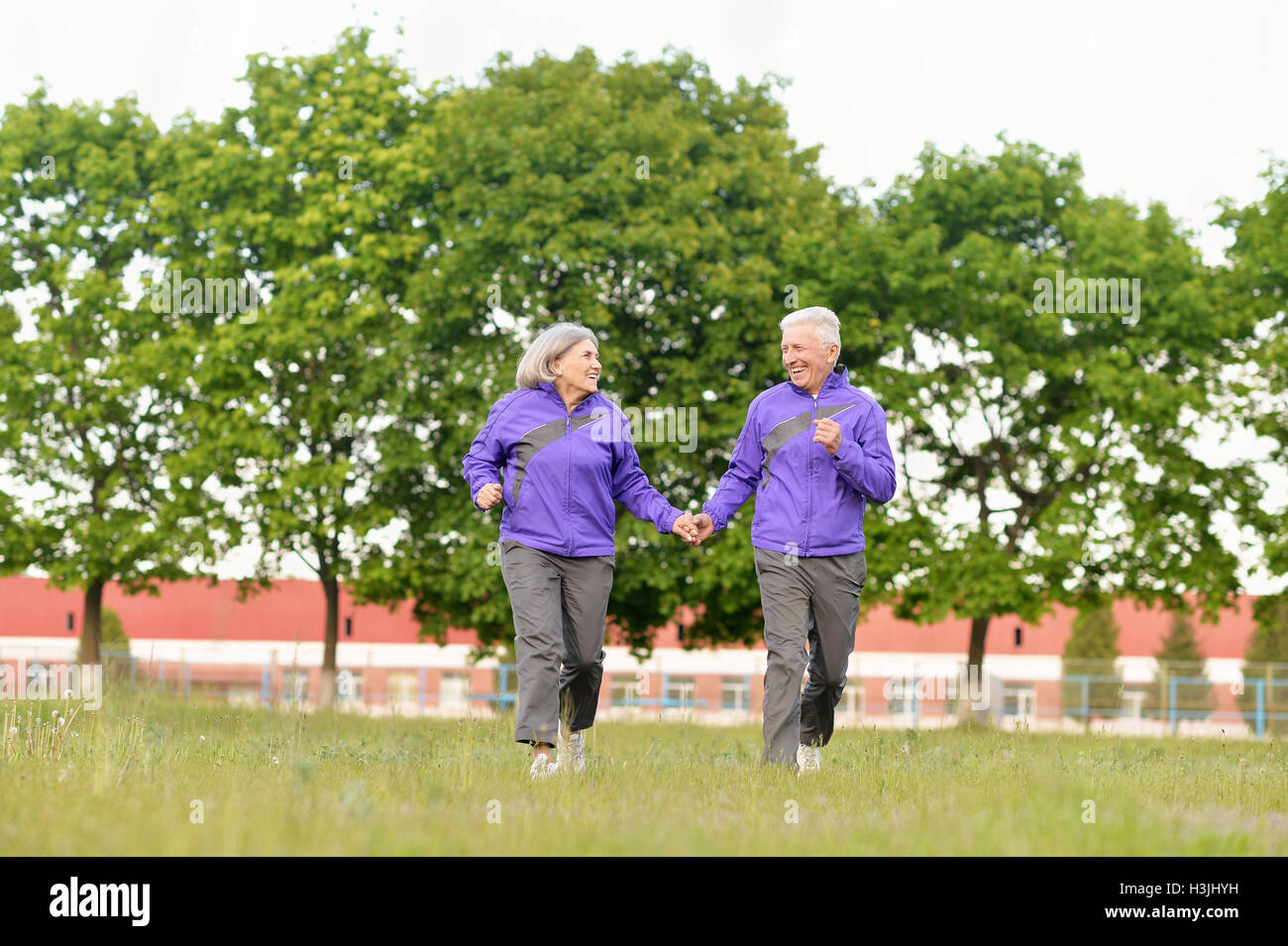 Senior couple jogging in park Stock Photo - Alamy