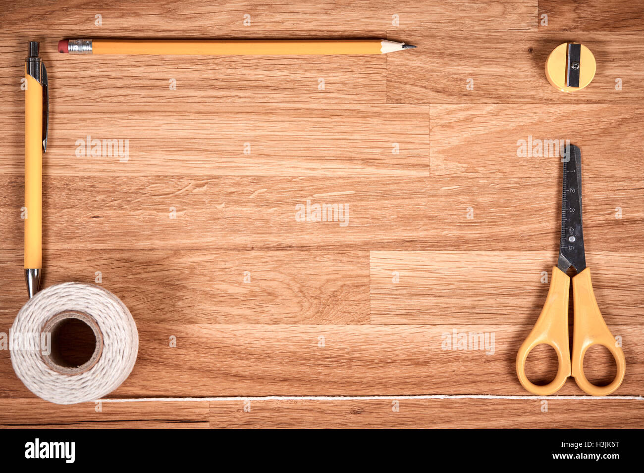 Cord, string, pencil, pen and sharpener on brown wooden oiled oak table ...