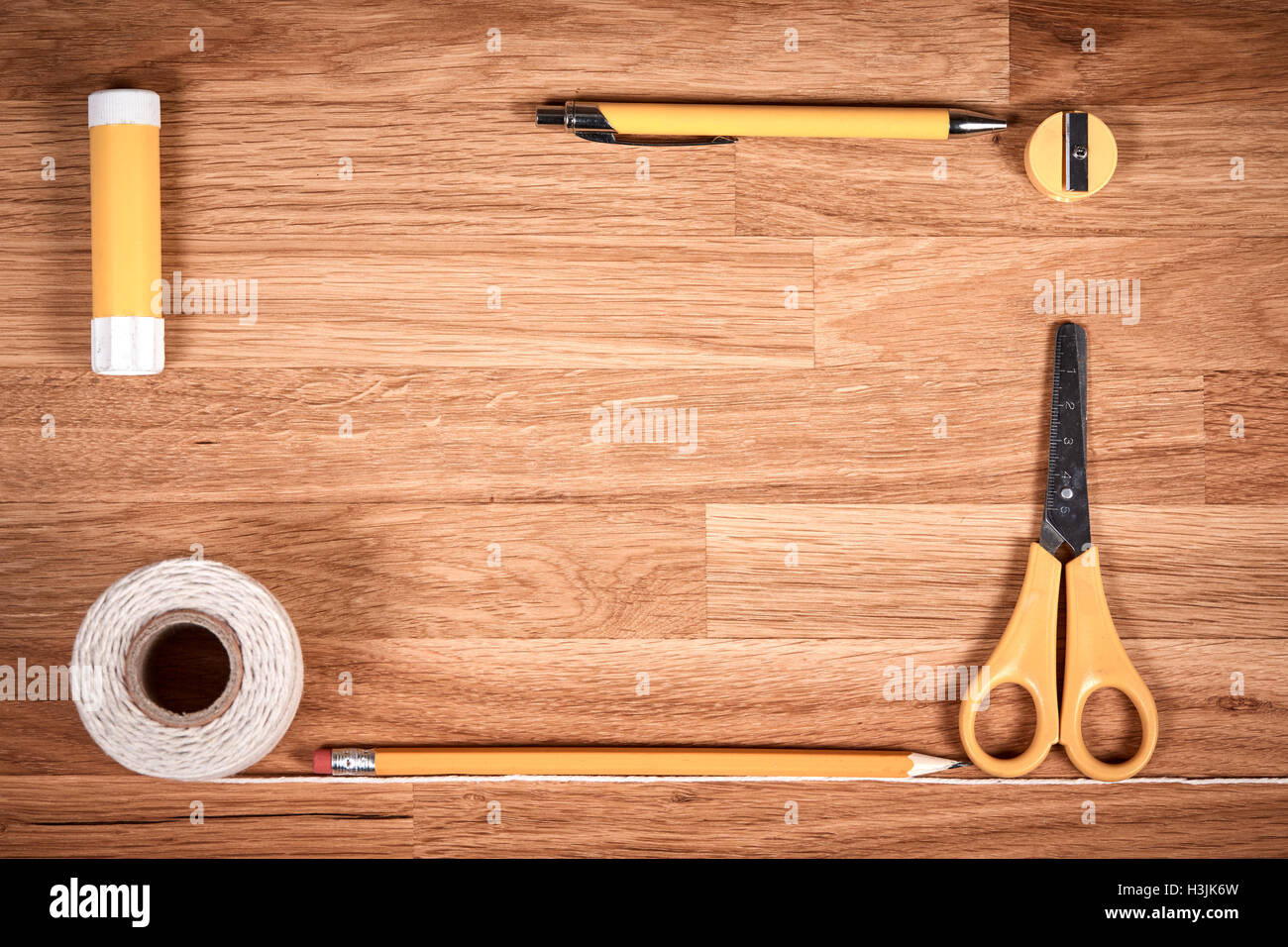 Cord, string, pencil, pen and sharpener on brown wooden oiled oak table ...