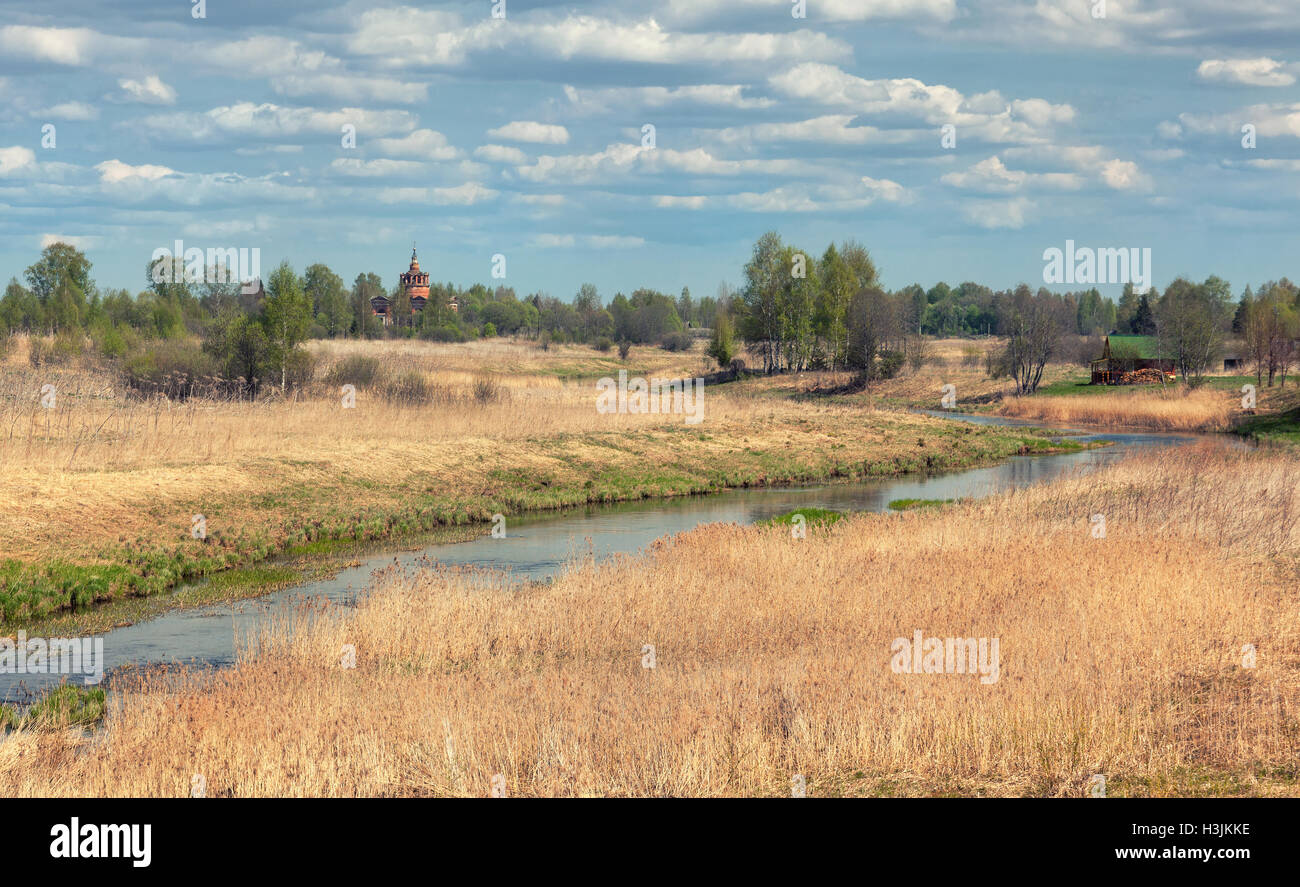 Rural landscape with high dry grass on a background of a bend of the ...