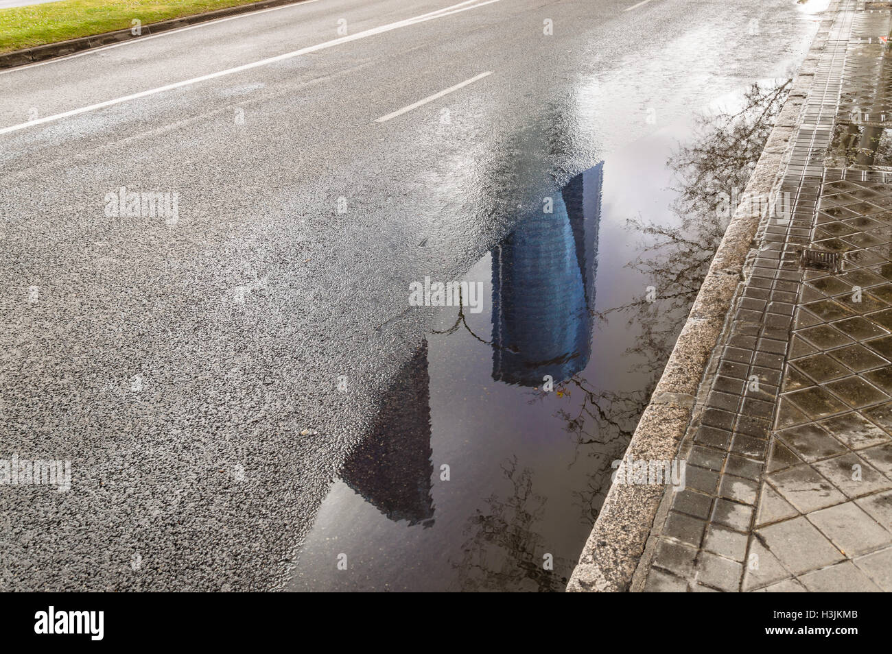 Architecture reflections on the puddle. Skyscrapers on a rainy day ...