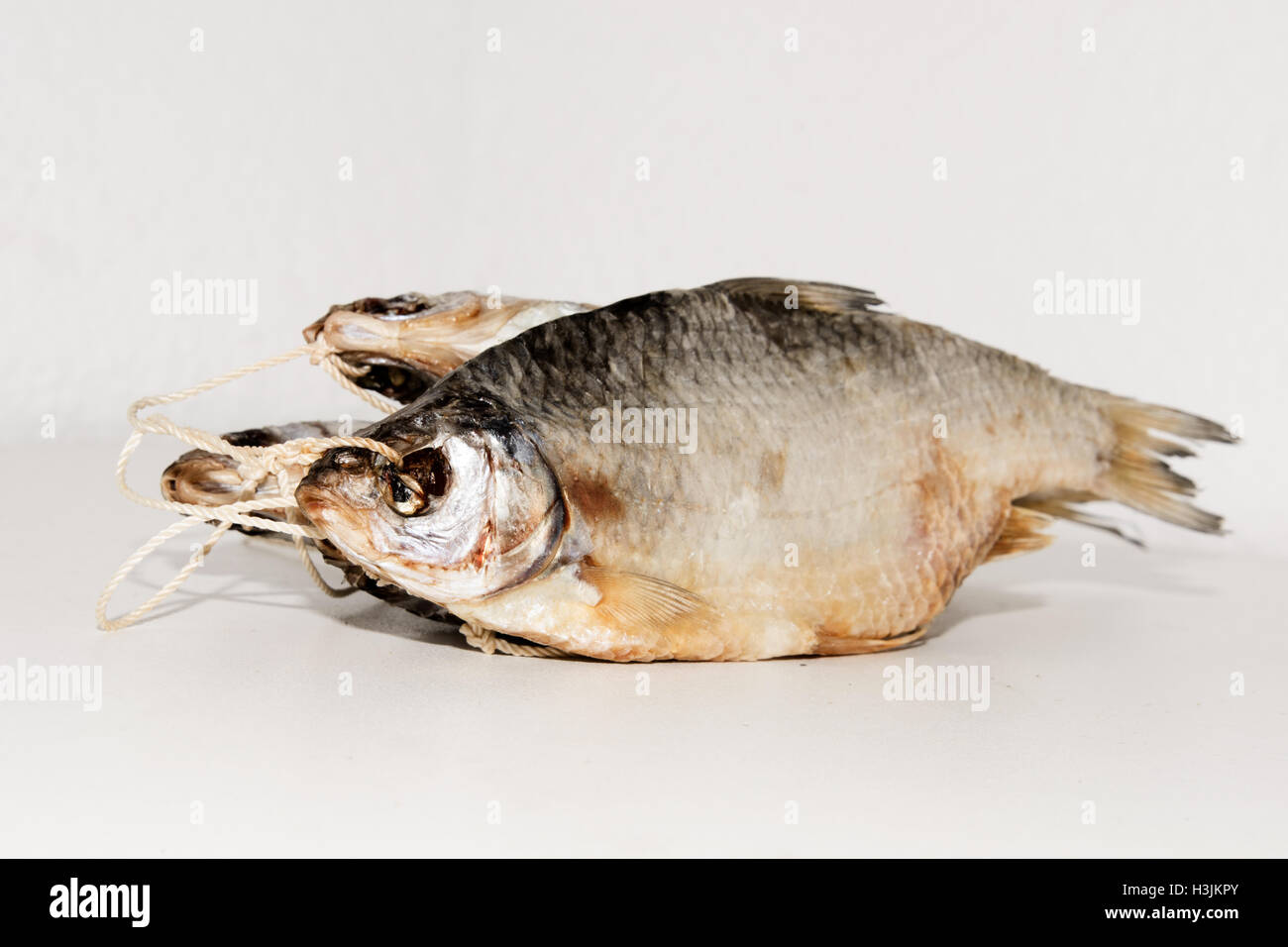 Dried fish on the table. Salty dry river fish on a white background ...