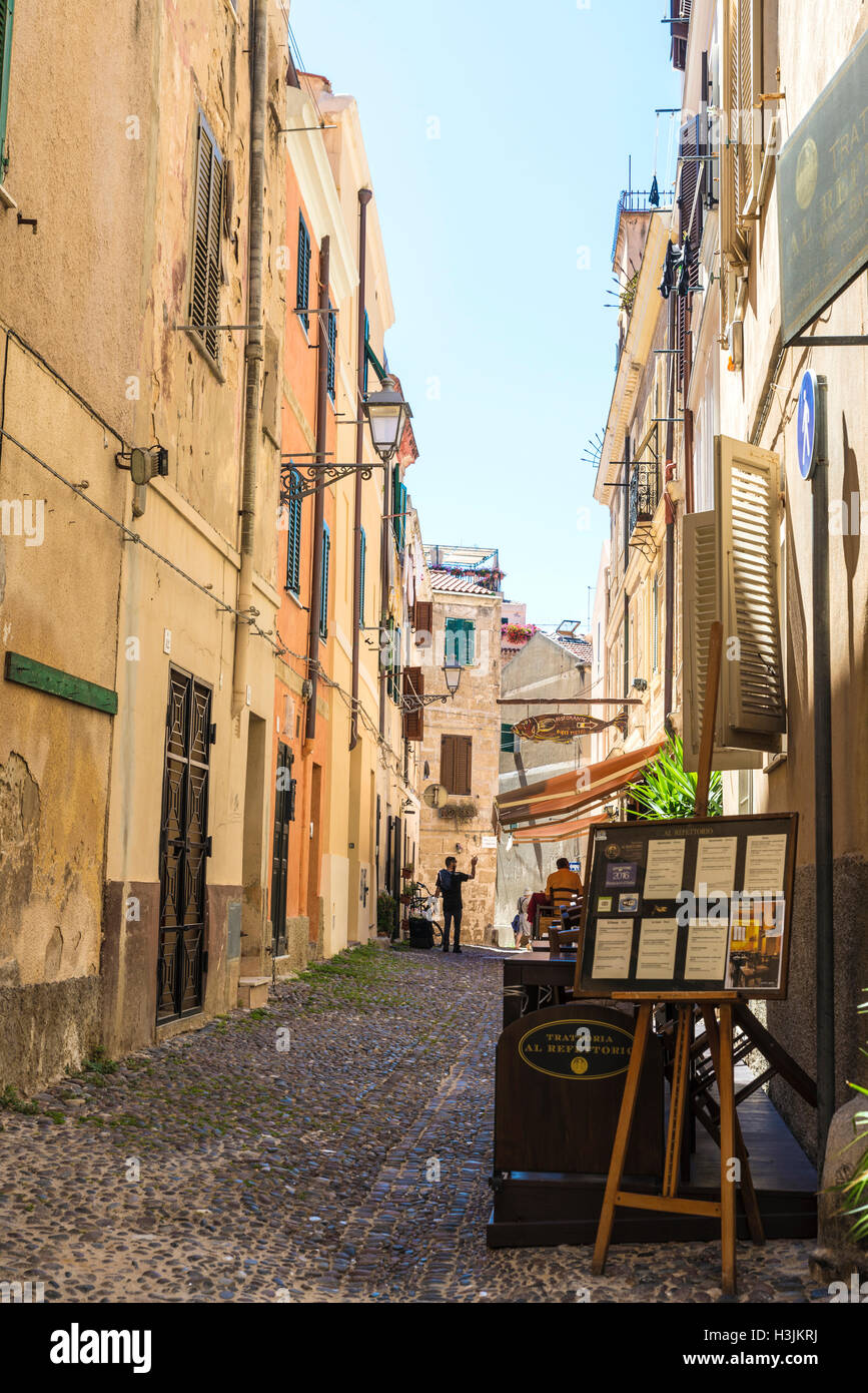 Street of the old town with people walking in Alghero, Sardinia, Italy ...