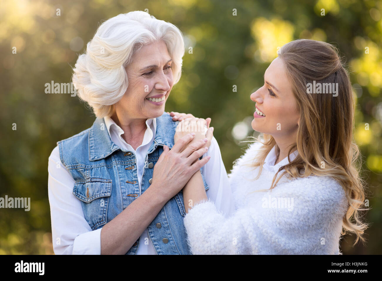 Two charming woman hawing a walk Stock Photo - Alamy