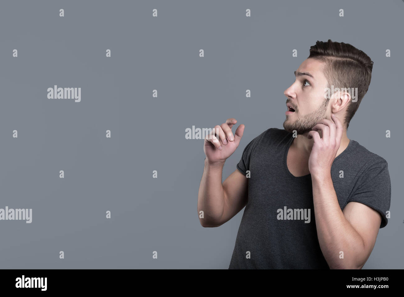 Scared young man raising hands Stock Photo - Alamy