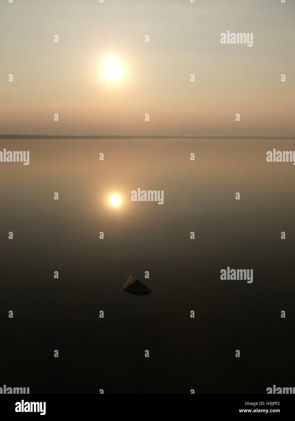 Setting sun and glassy smooth water, Lake Unden, Sweden Stock Photo - Alamy