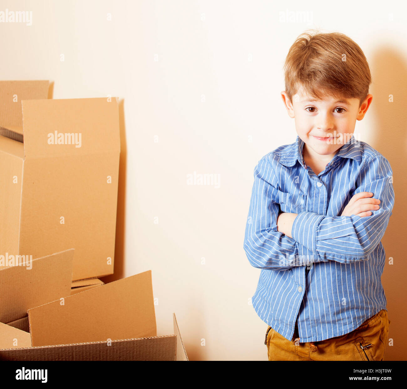 little cute boy in empty room, remoove to new house. home alone emong ...