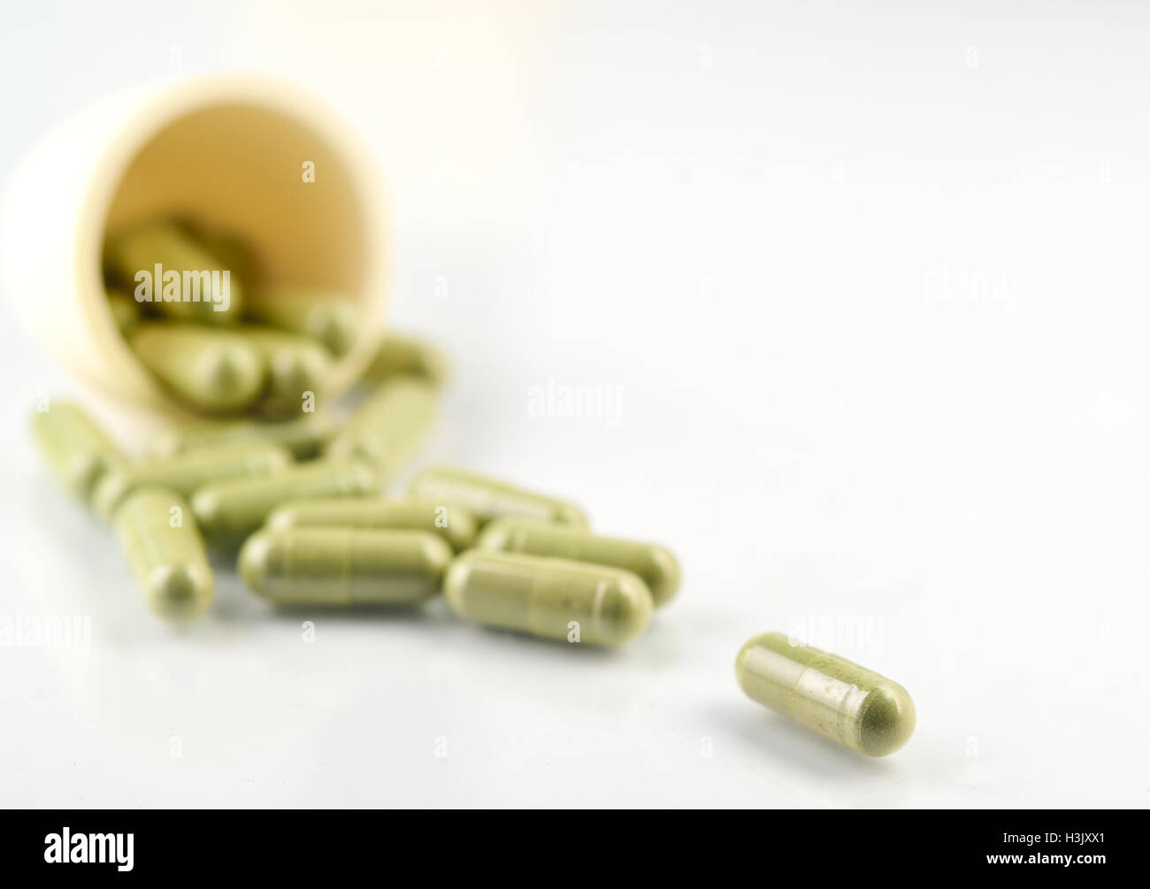 herb capsules on white background Stock Photo - Alamy