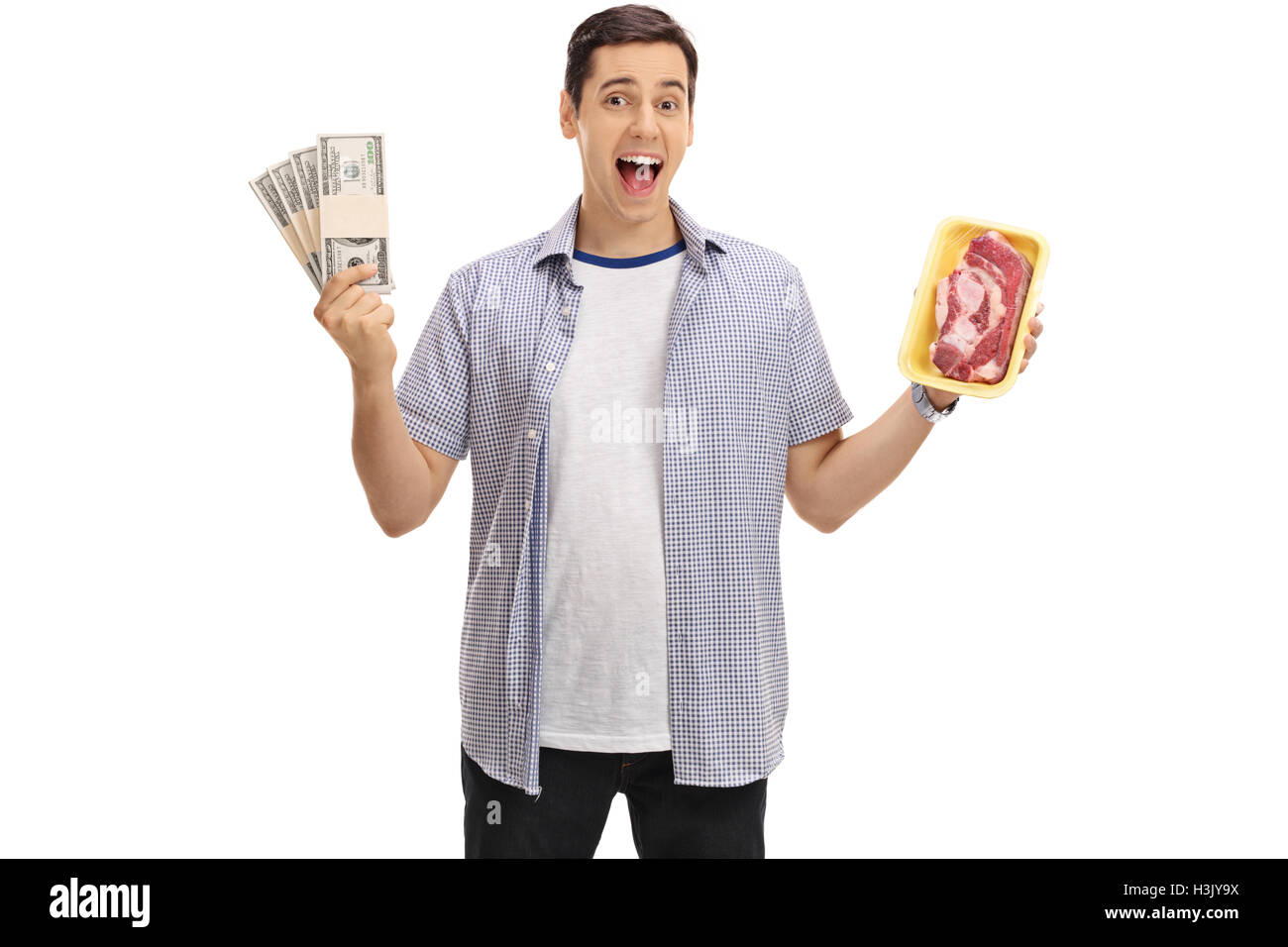 Cheerful man holding bundles of money and a steak isolated on white ...