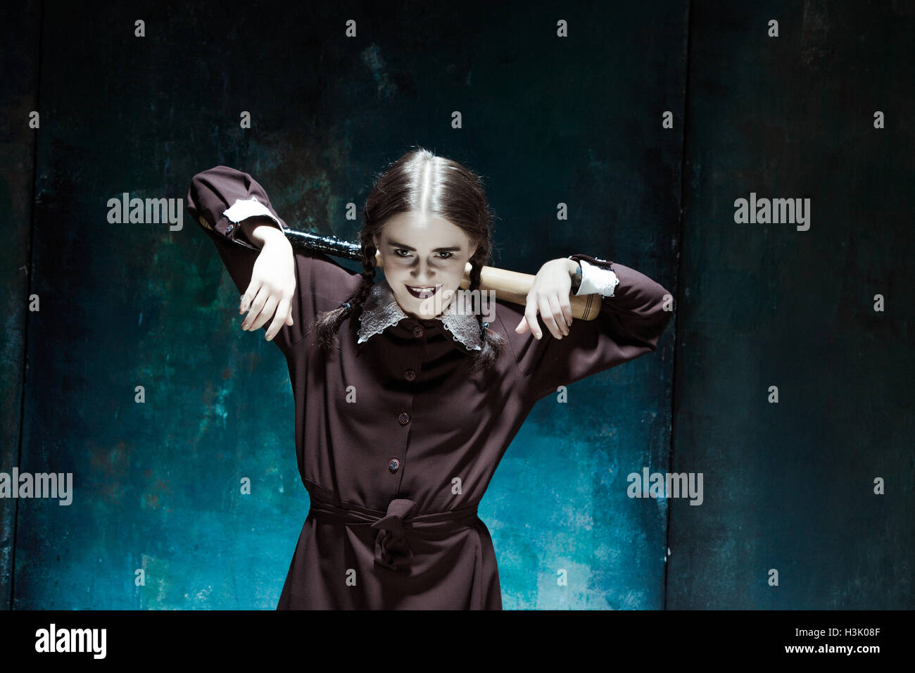 Portrait of a young girl in school uniform as killer woman Stock Photo ...