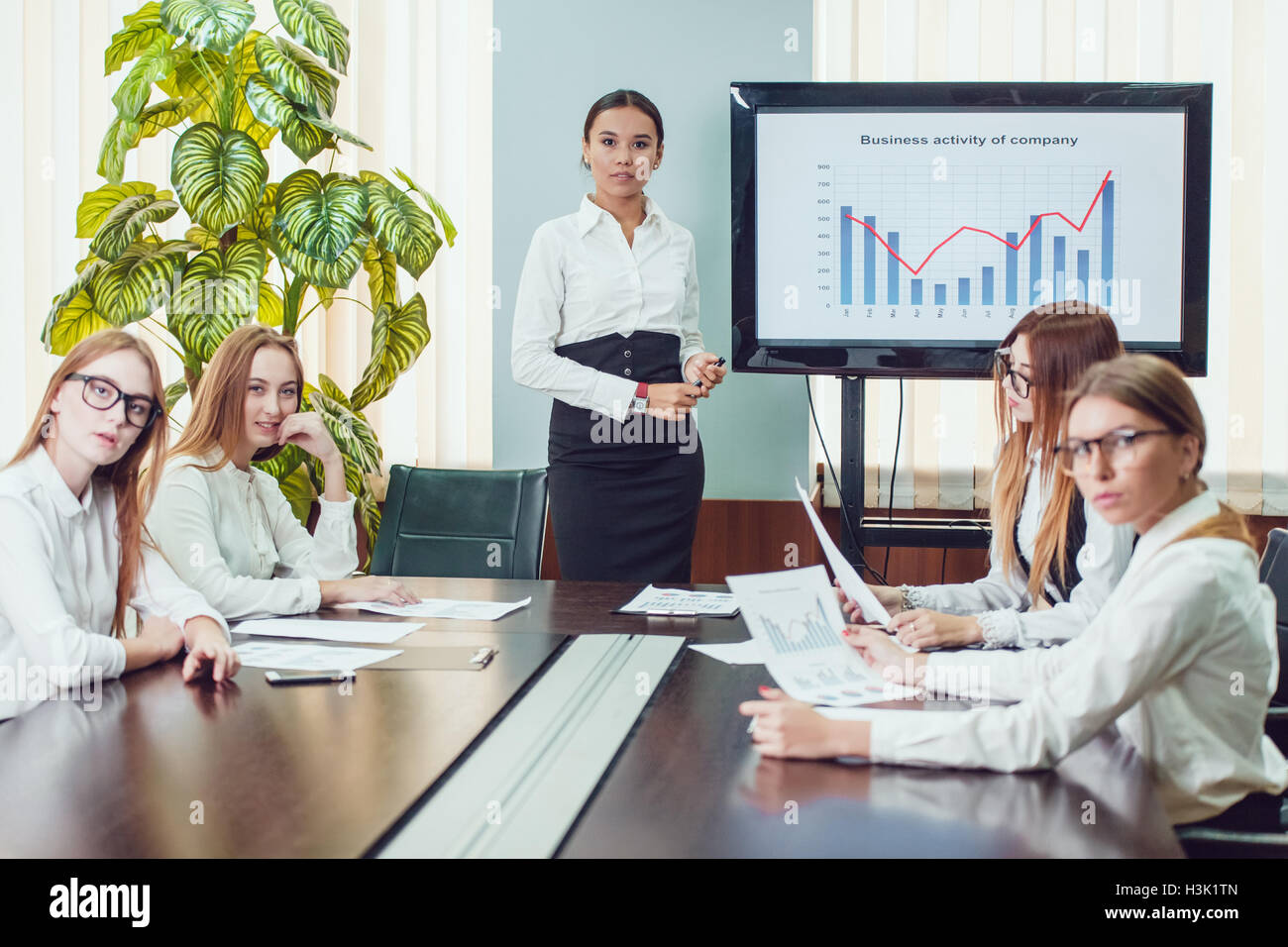 Asian manager presenting business activity plan to his colleagues Stock ...