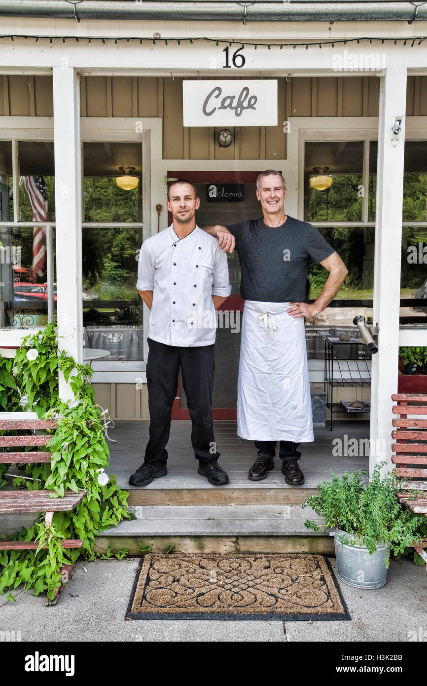 Cafe owner and chef posing in front of restaurant Stock Photo - Alamy