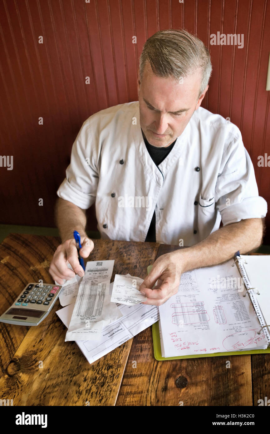 Chef working on accounts Stock Photo - Alamy