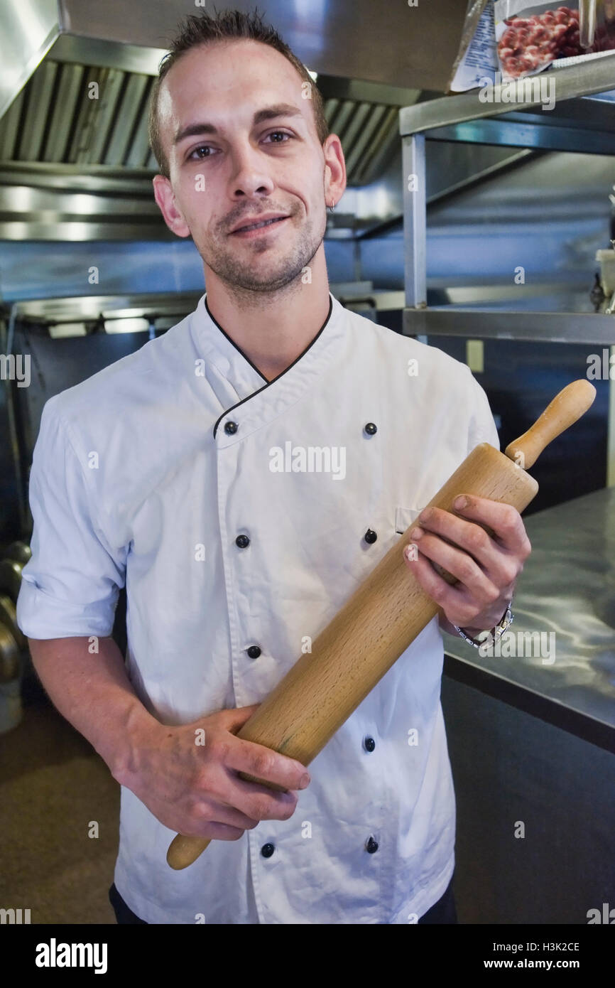 Chef with rolling pin in kitchen Stock Photo - Alamy
