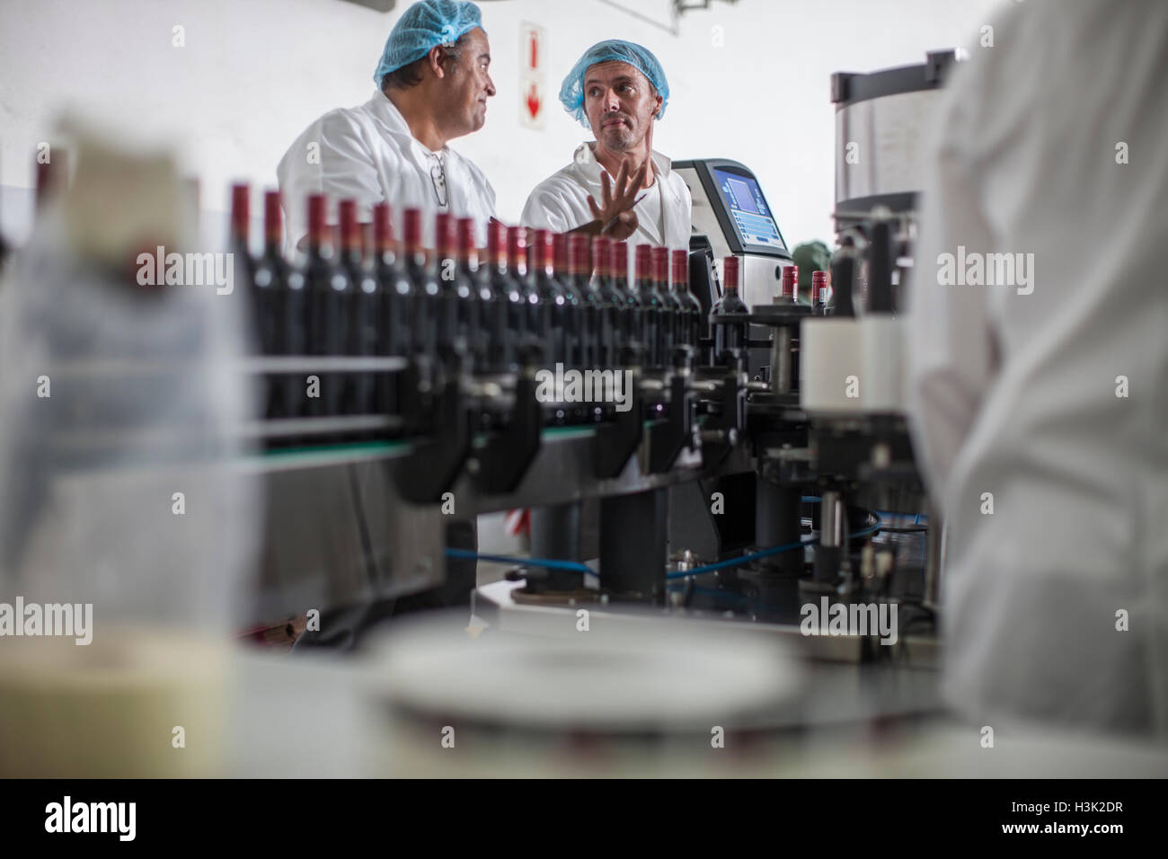 Factory workers on production line of wine bottling plant Stock Photo ...