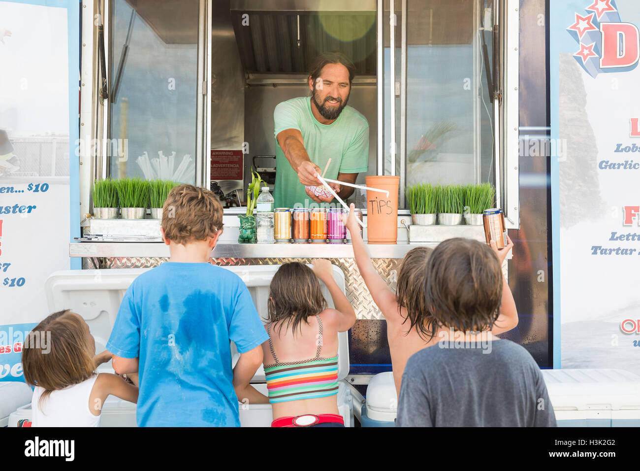 Group of children queuing at fast food trailer Stock Photo - Alamy