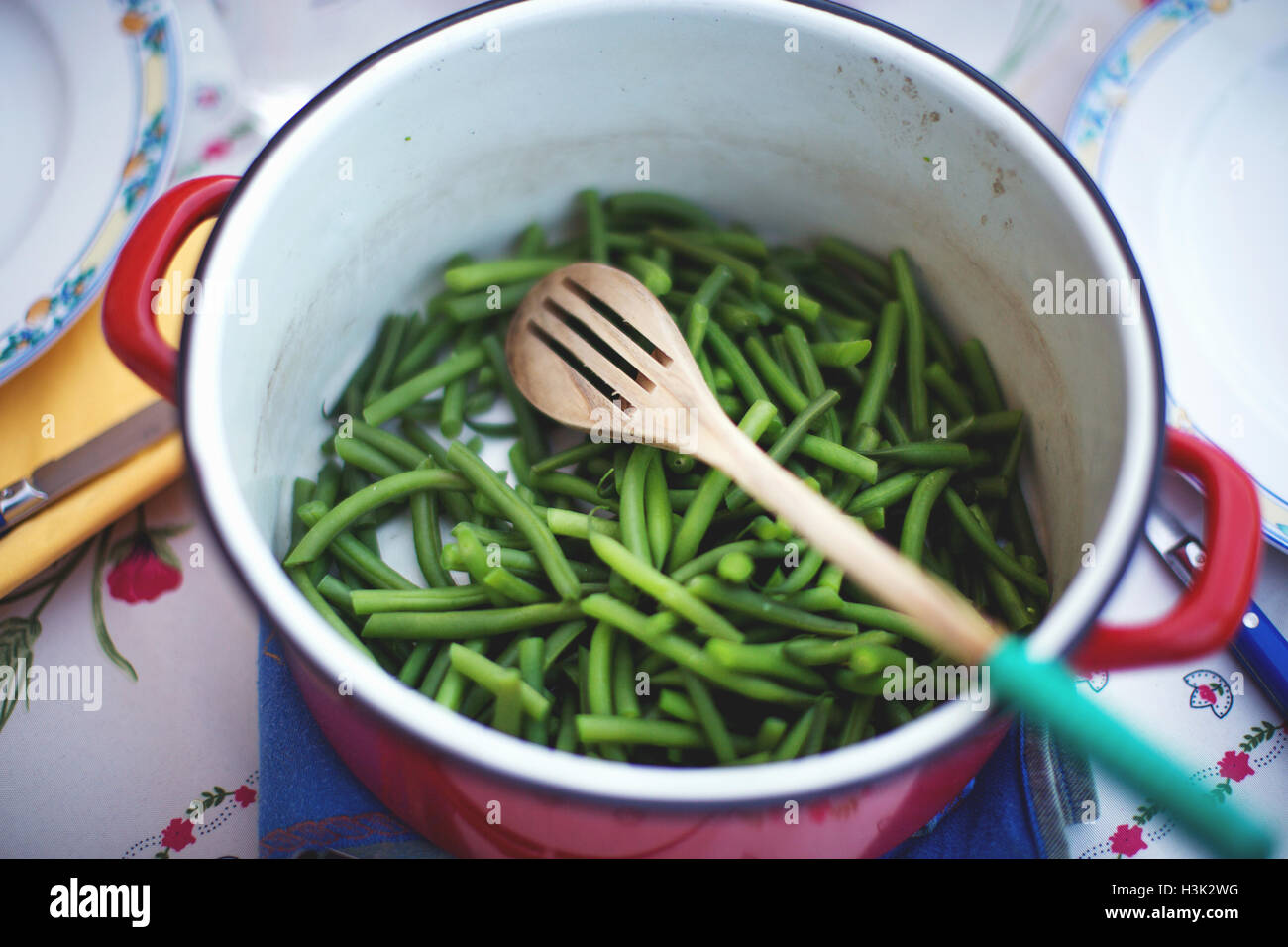 Green beans in cooking pot with wooden spoon, elevated view Stock Photo ...