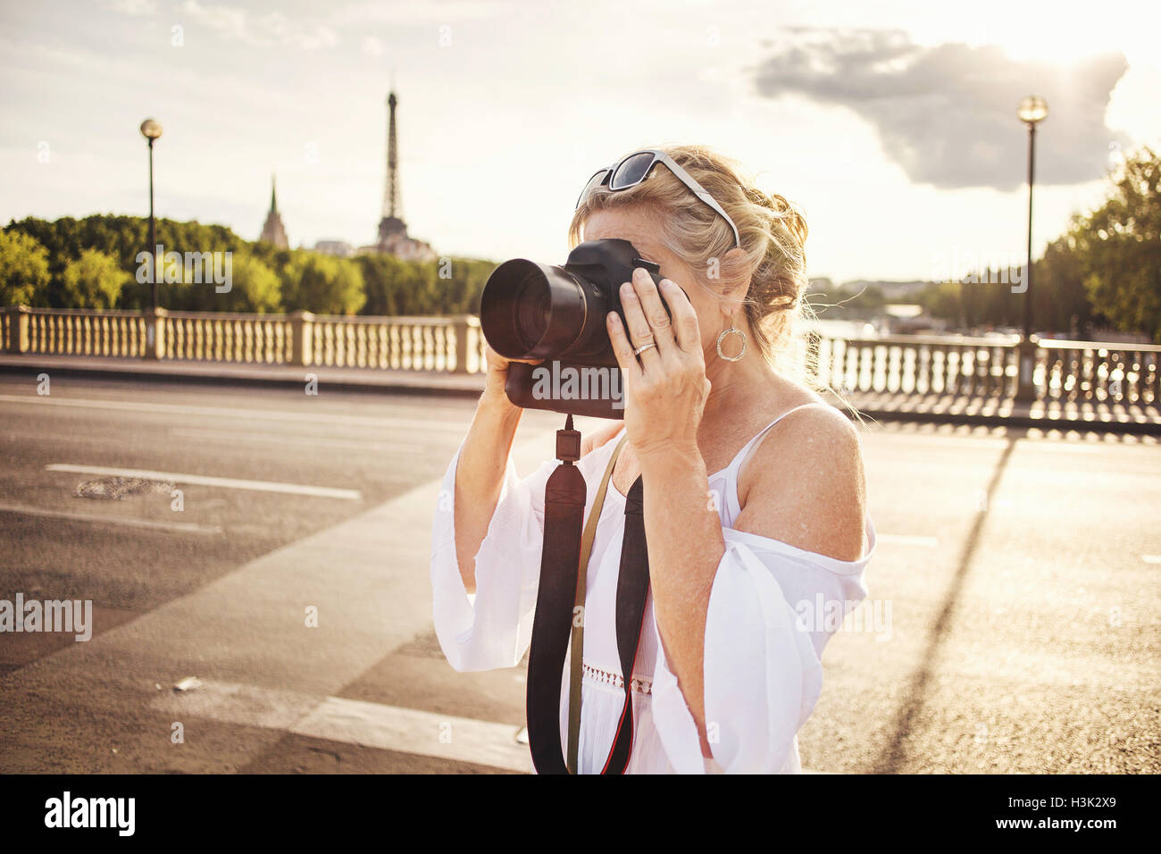 Senior woman taking photograph with camera, Paris, France Stock Photo ...