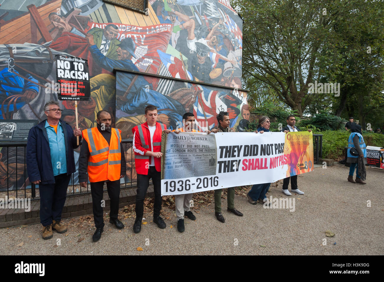 London, UK. 9th October 2016. People pose with the banner that led the ...