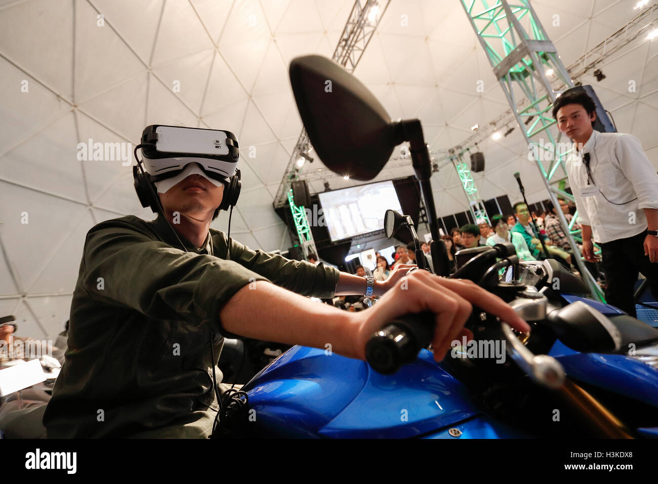 A visitor tries a virtual reality simulator during the Tokyo Motor Fes ...