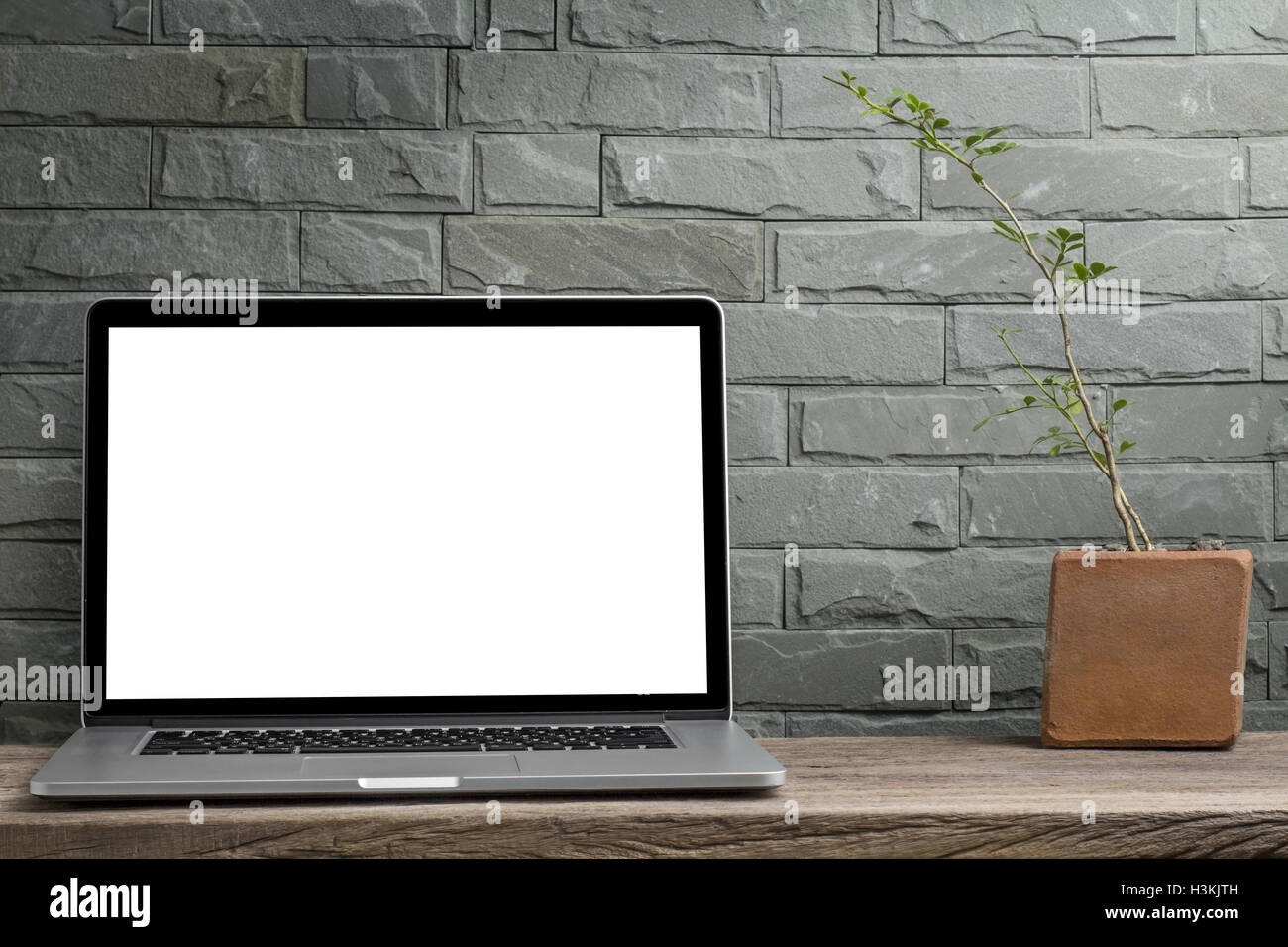 Laptop blank screen on old wooden desk wall bricks background Stock ...