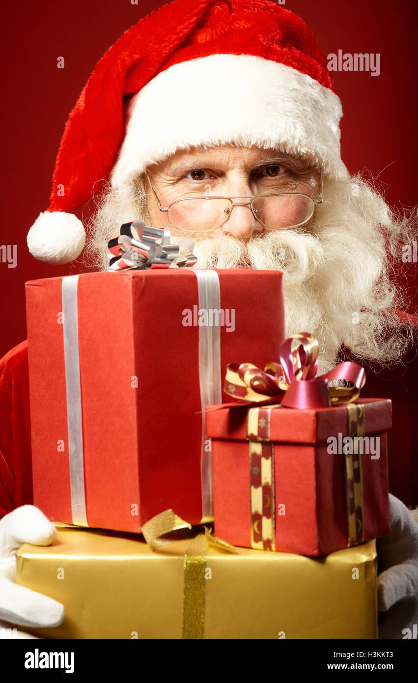 Santa Claus with gift boxes Stock Photo - Alamy